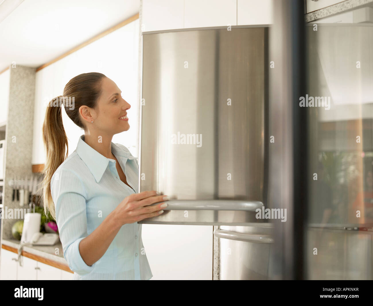Young woman at freezer Stock Photo - Alamy