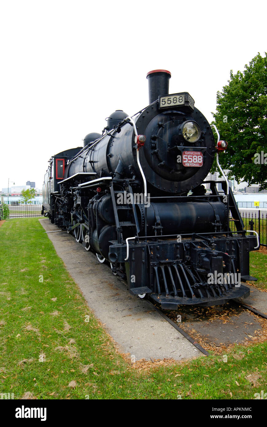 A large historic steam powered locomotive train stands in the water ...