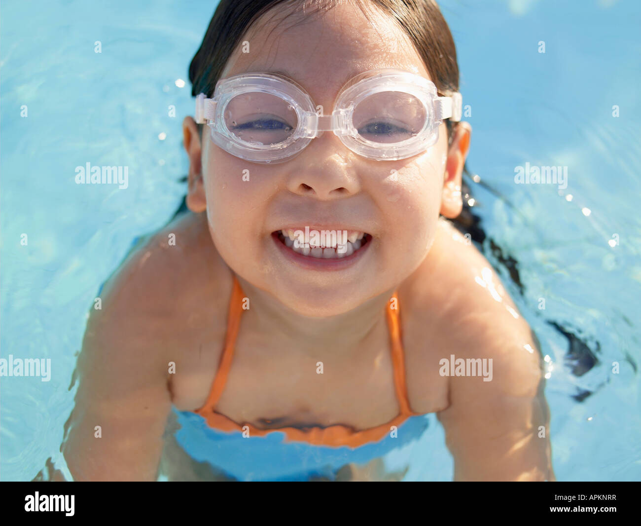 Young girl wearing swimming goggles (portrait, high angle view Stock ...