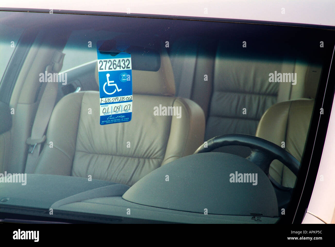handicapped parking permit sign in a car windshield allows person to ...