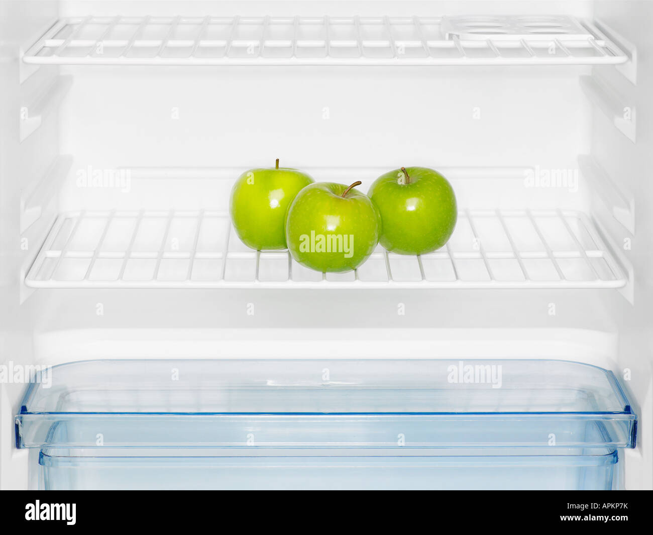 Three green apples in fridge (close-up Stock Photo - Alamy