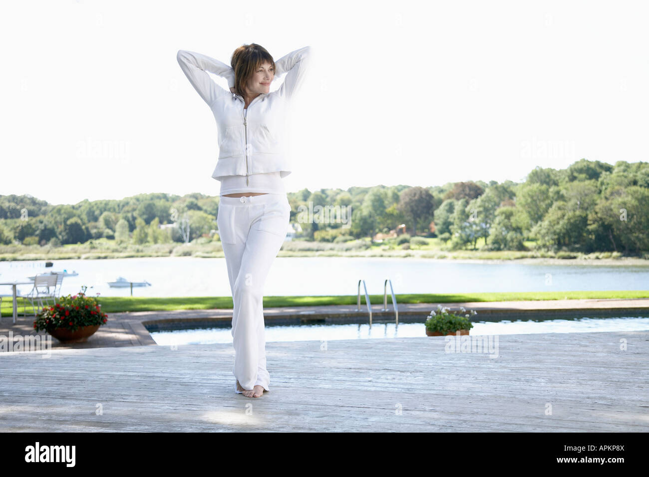 Woman stretching near pool Stock Photo - Alamy