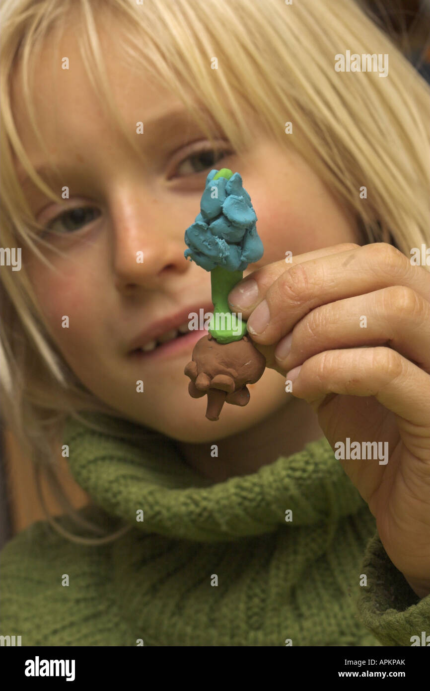kids tinker flowers of modeling clay Stock Photo - Alamy