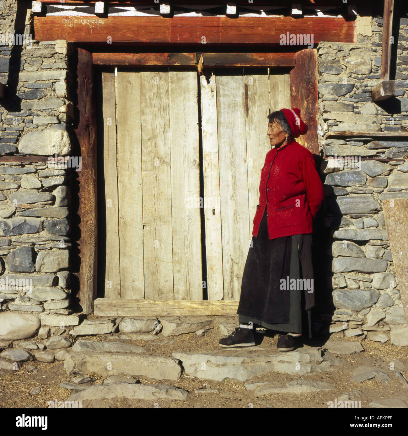 proudful woman of the Kham-people in front of her courtyard, China ...