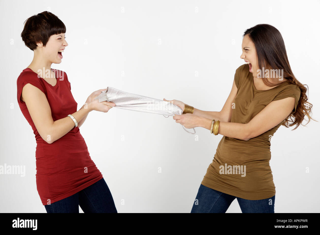 Two woman fighting for clothes Stock Photo - Alamy