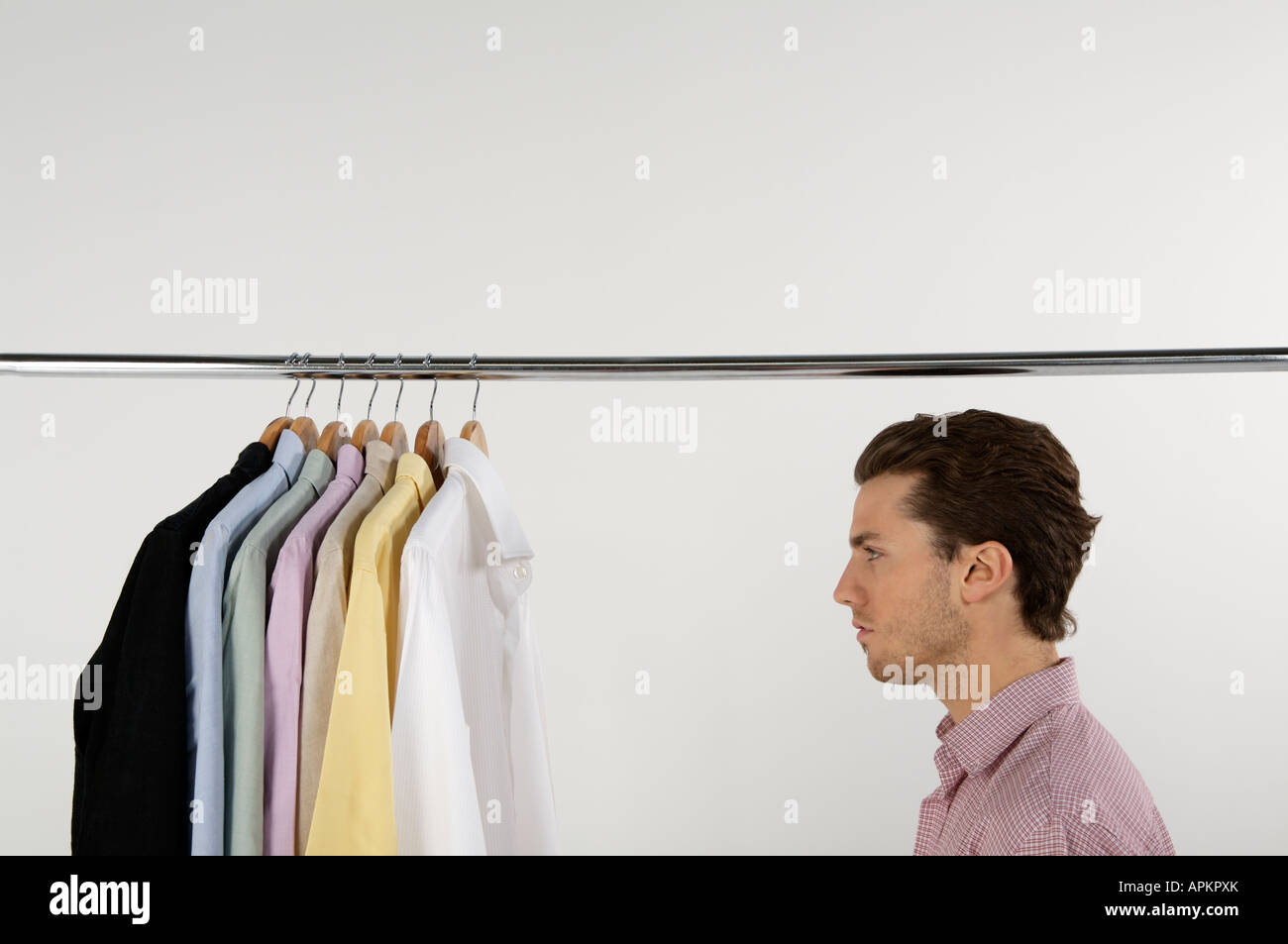 Young man with clothing rack Stock Photo - Alamy