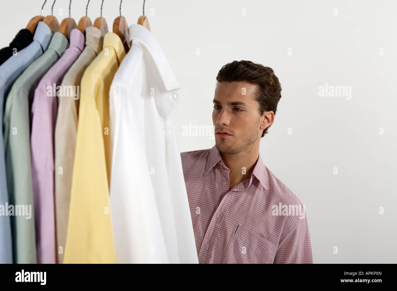 Young man with clothing rack Stock Photo - Alamy