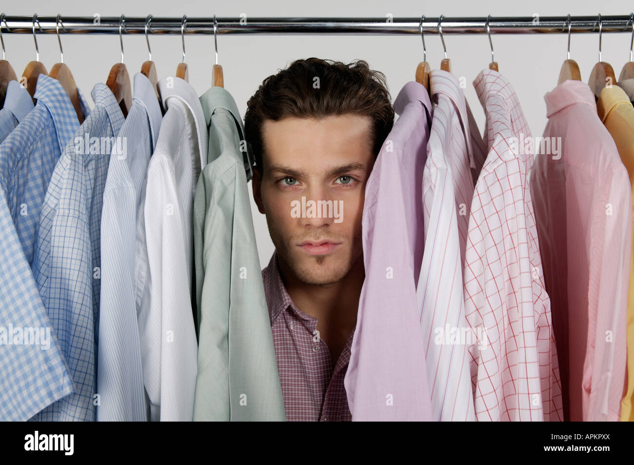 Young man with clothing rack Stock Photo - Alamy