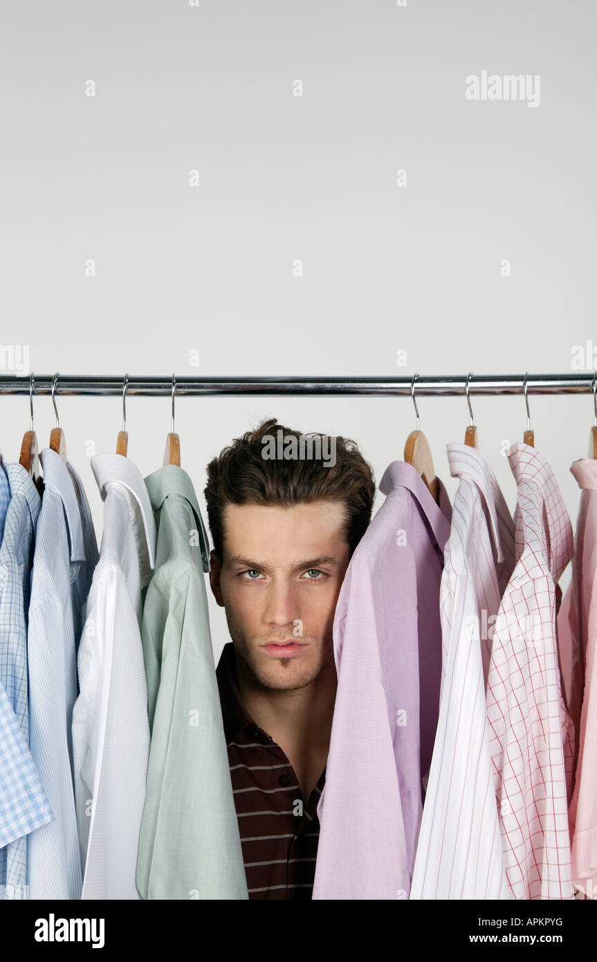 Young man with clothing rack Stock Photo - Alamy