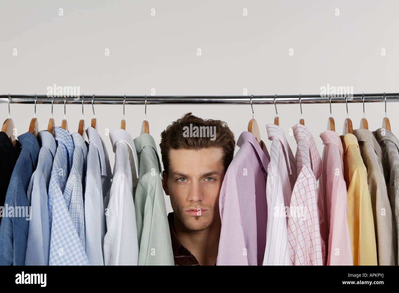 Young man with clothing rack Stock Photo - Alamy