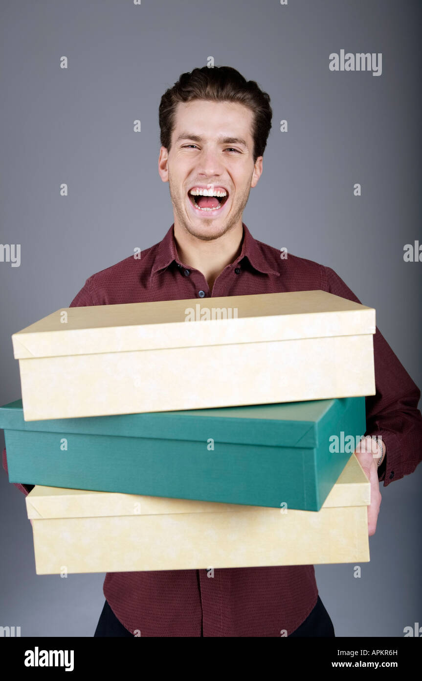 Young man holding boxes Stock Photo - Alamy