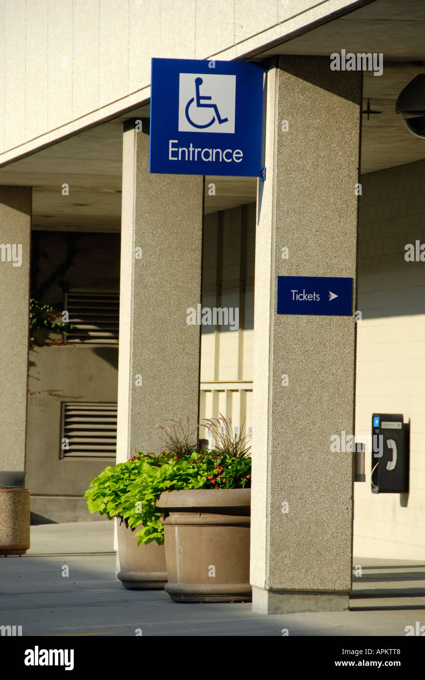 Large handicapped blue and white sign draw attention to an entrance for ...