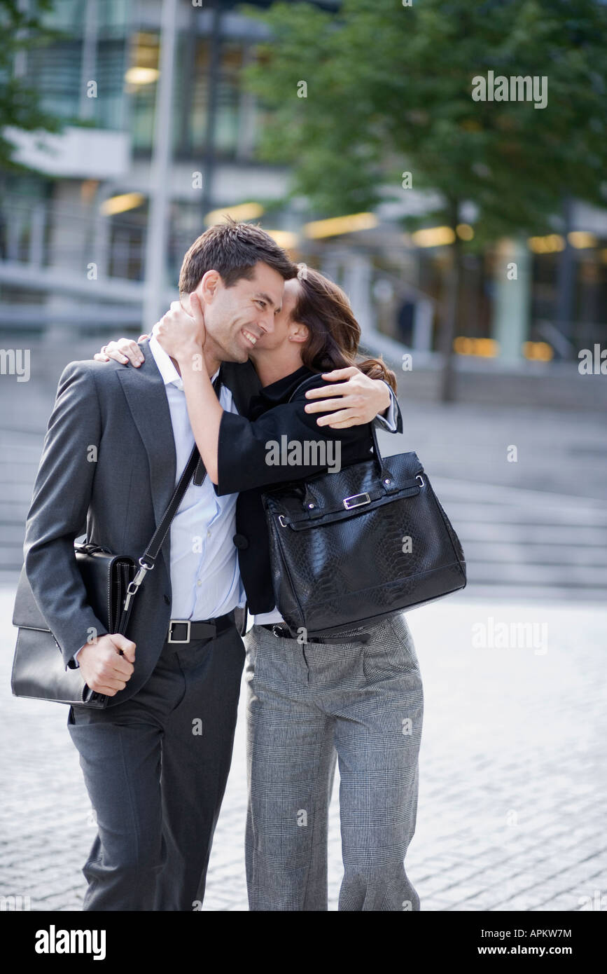Couple hugging at public square Stock Photo - Alamy