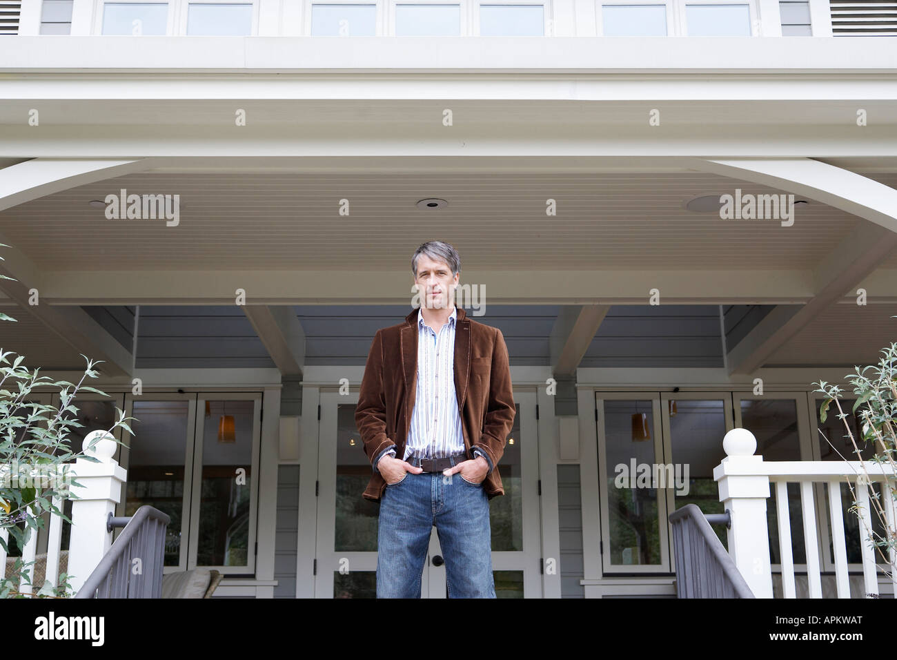 Man standing outside house (portrait, low angle view Stock Photo - Alamy