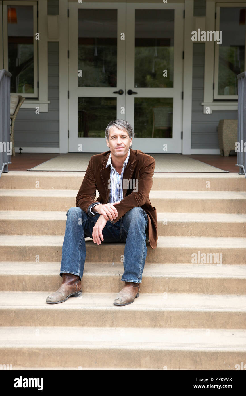 Man sitting on steps Stock Photo - Alamy