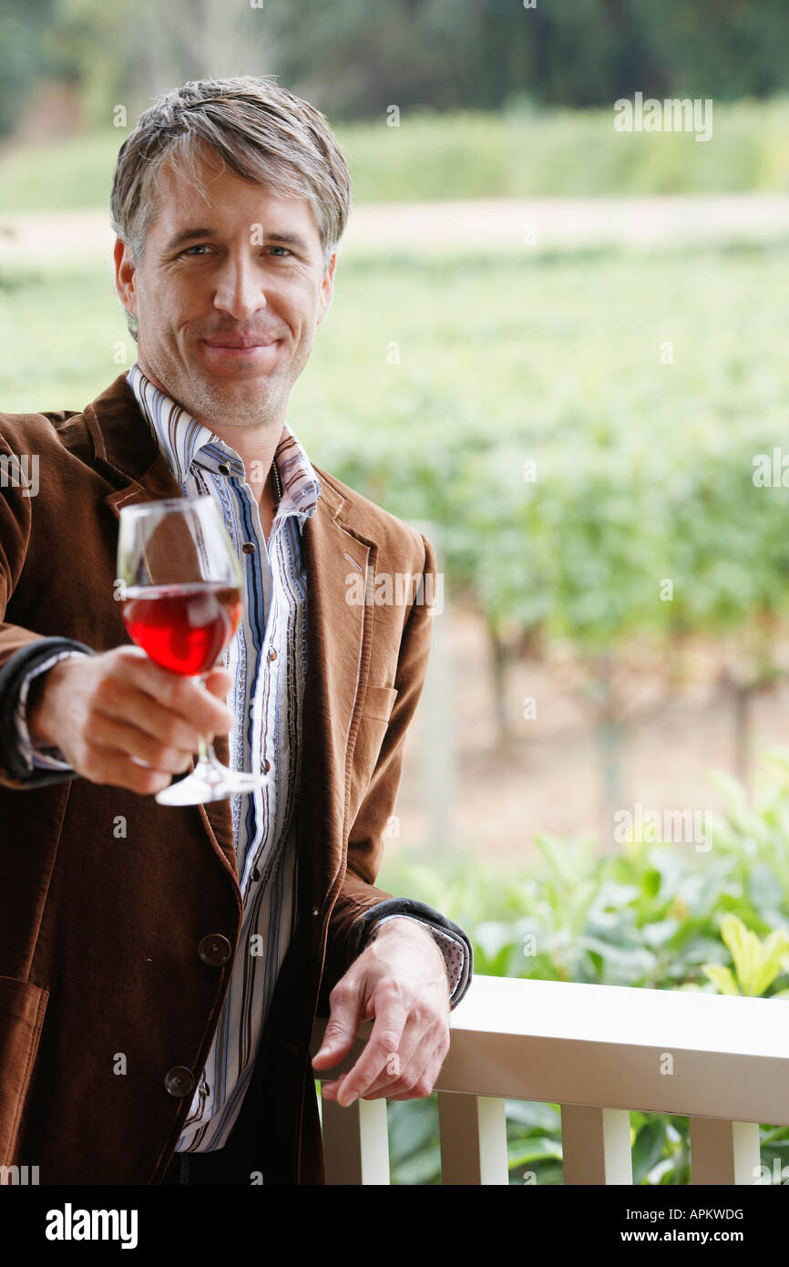 Mid adult man toasting with red wine (portrait Stock Photo - Alamy