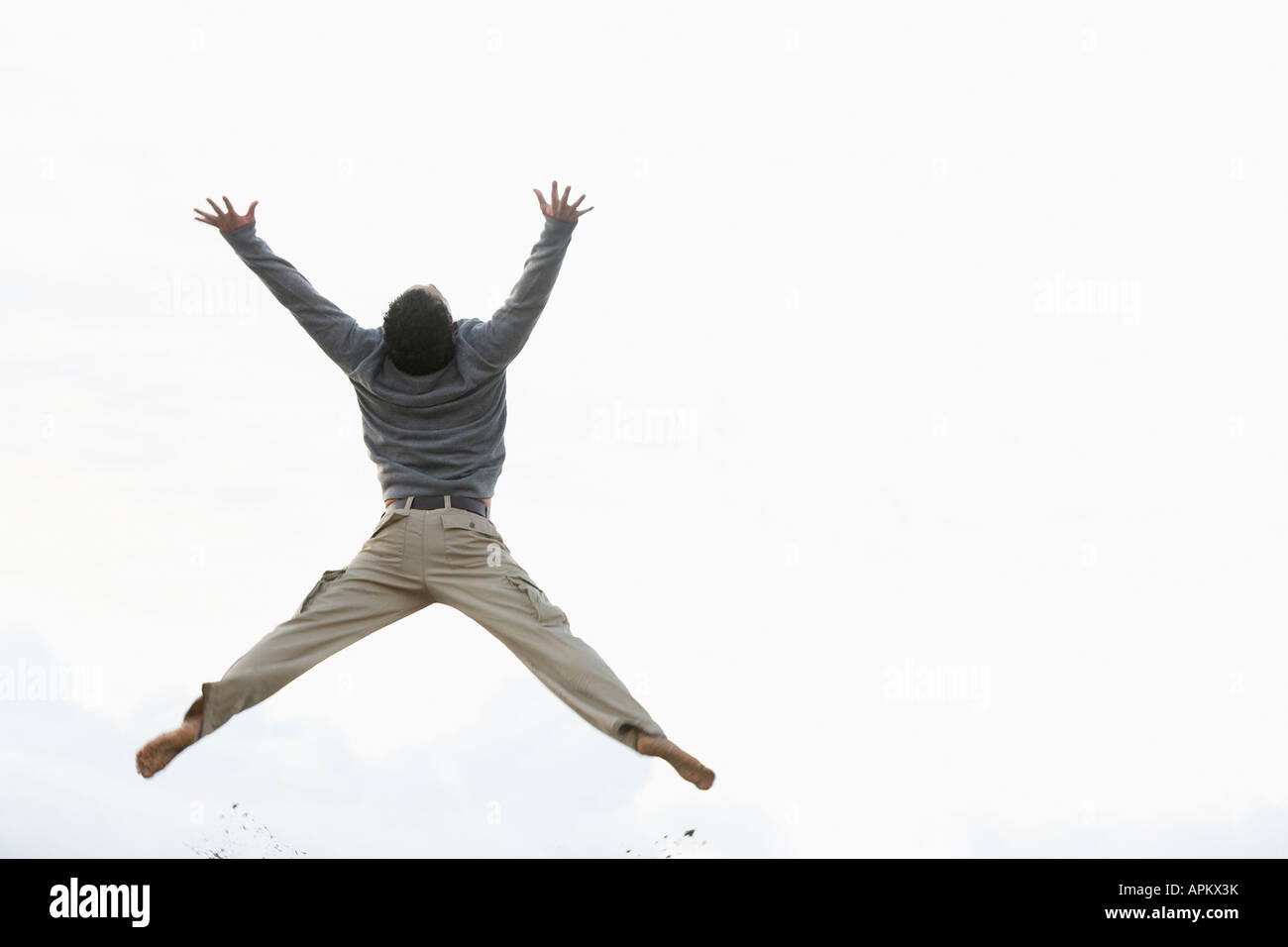 Man and woman jumping (rear view Stock Photo - Alamy