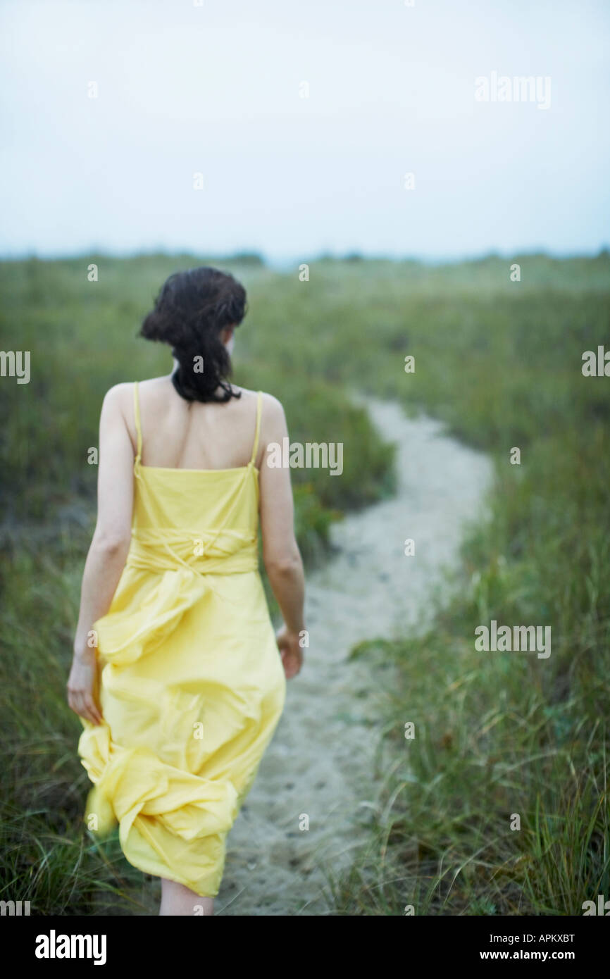 Young woman walking on path (rear view Stock Photo - Alamy