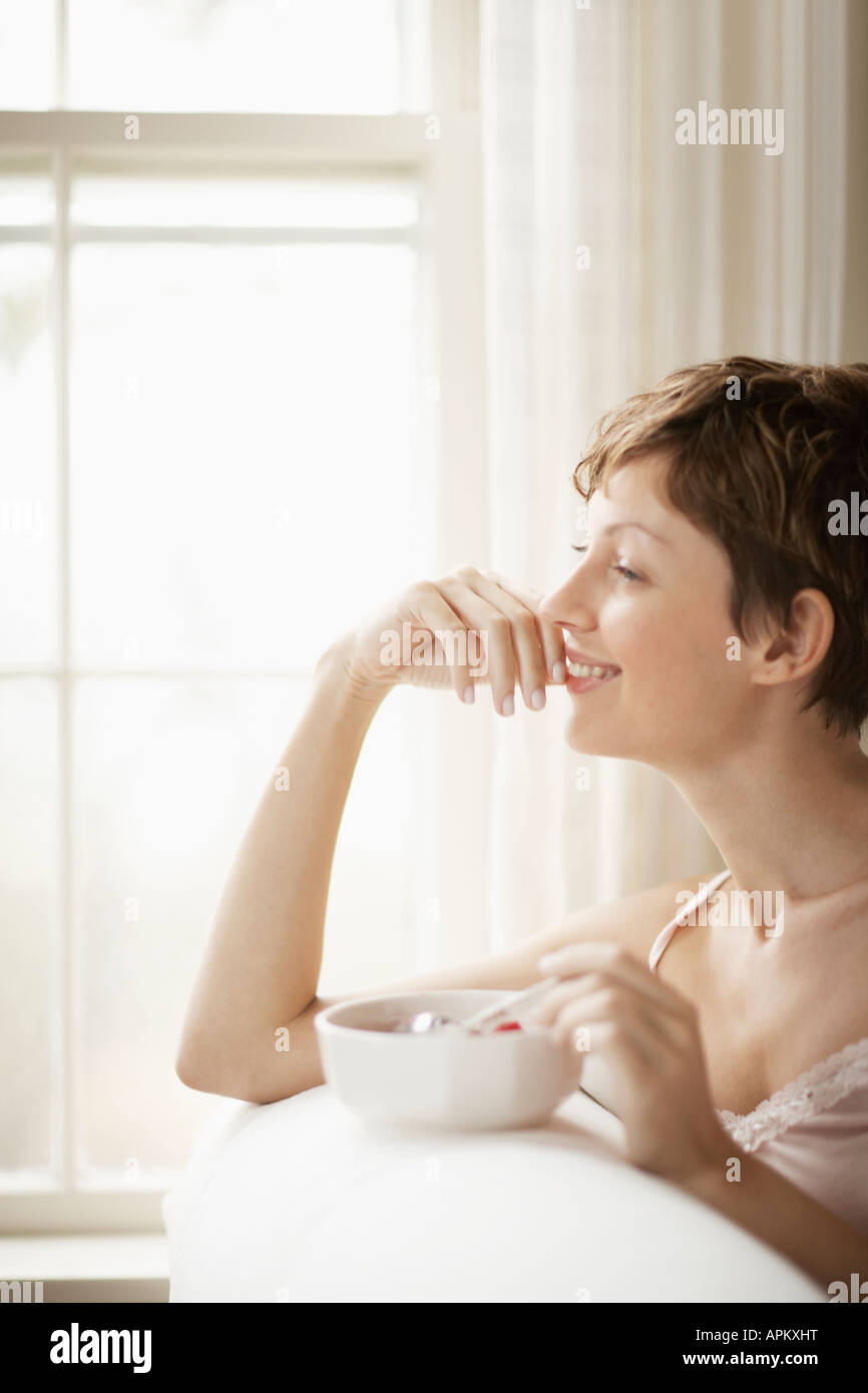Mid adult woman eating breakfast Stock Photo - Alamy