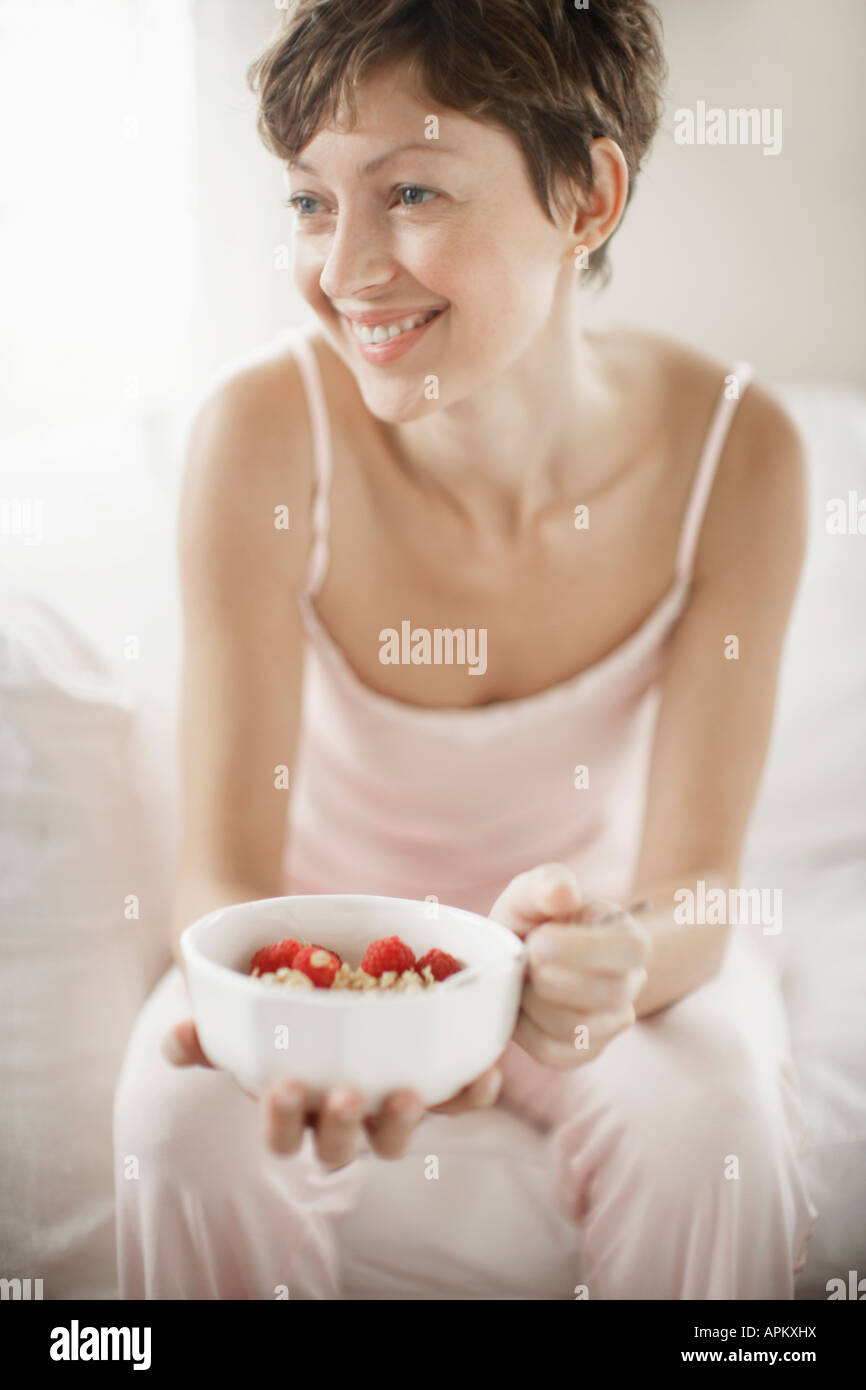Mid adult woman eating breakfast Stock Photo - Alamy