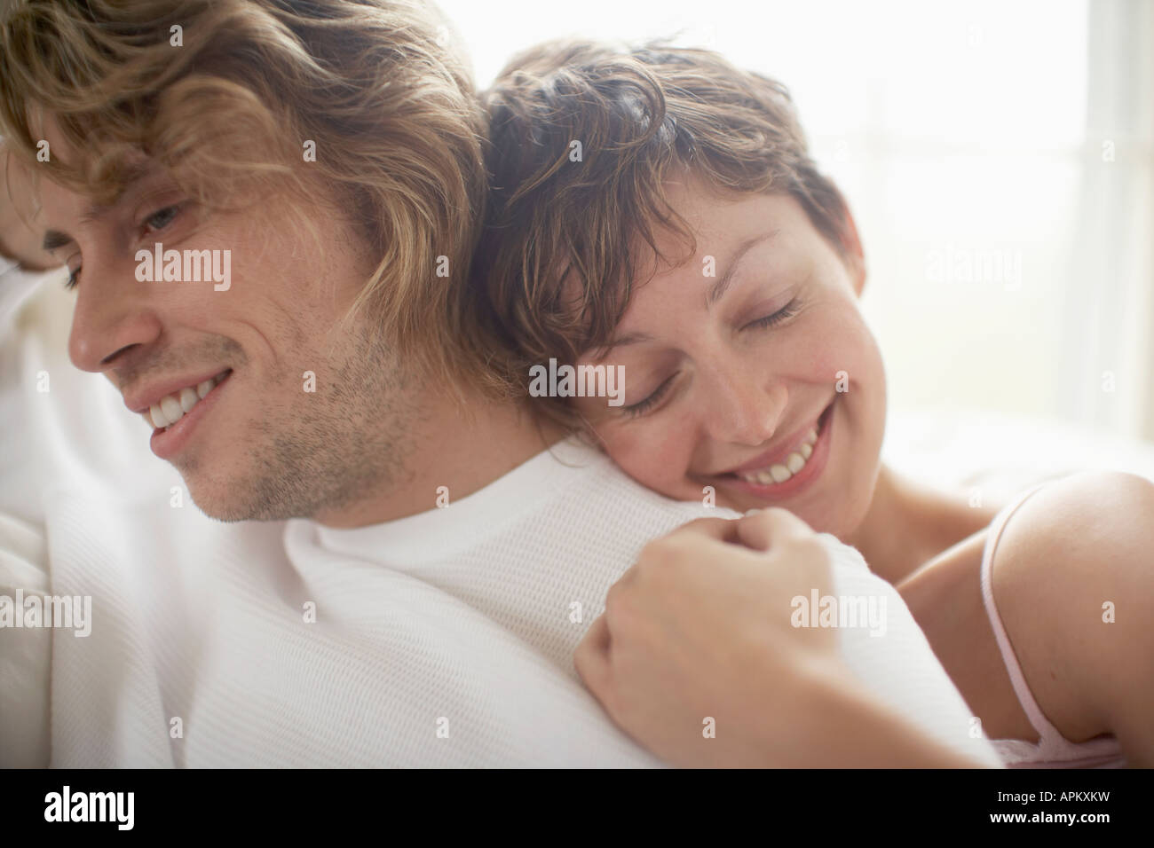 Woman hugging man from behind Stock Photo - Alamy