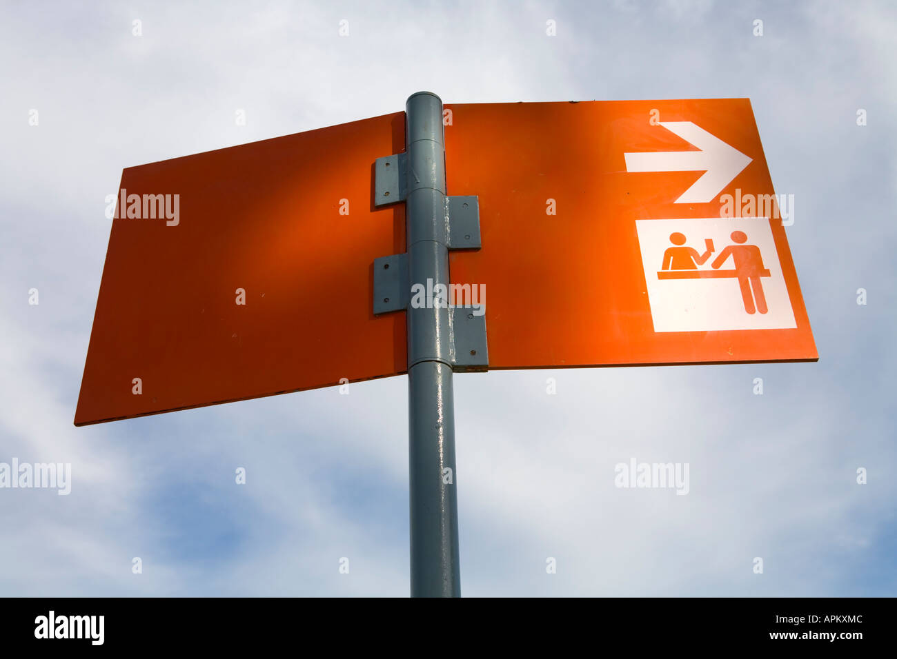 Sign outside railway station pointing to ticket box Stock Photo - Alamy