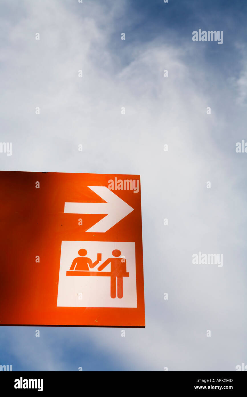 Sign outside railway station pointing to ticket box Stock Photo - Alamy