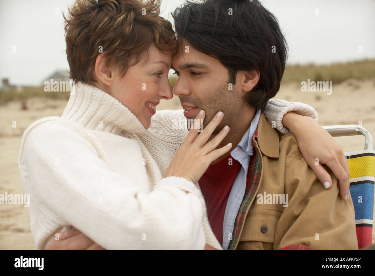 Couple hugging on lounge chair Stock Photo - Alamy