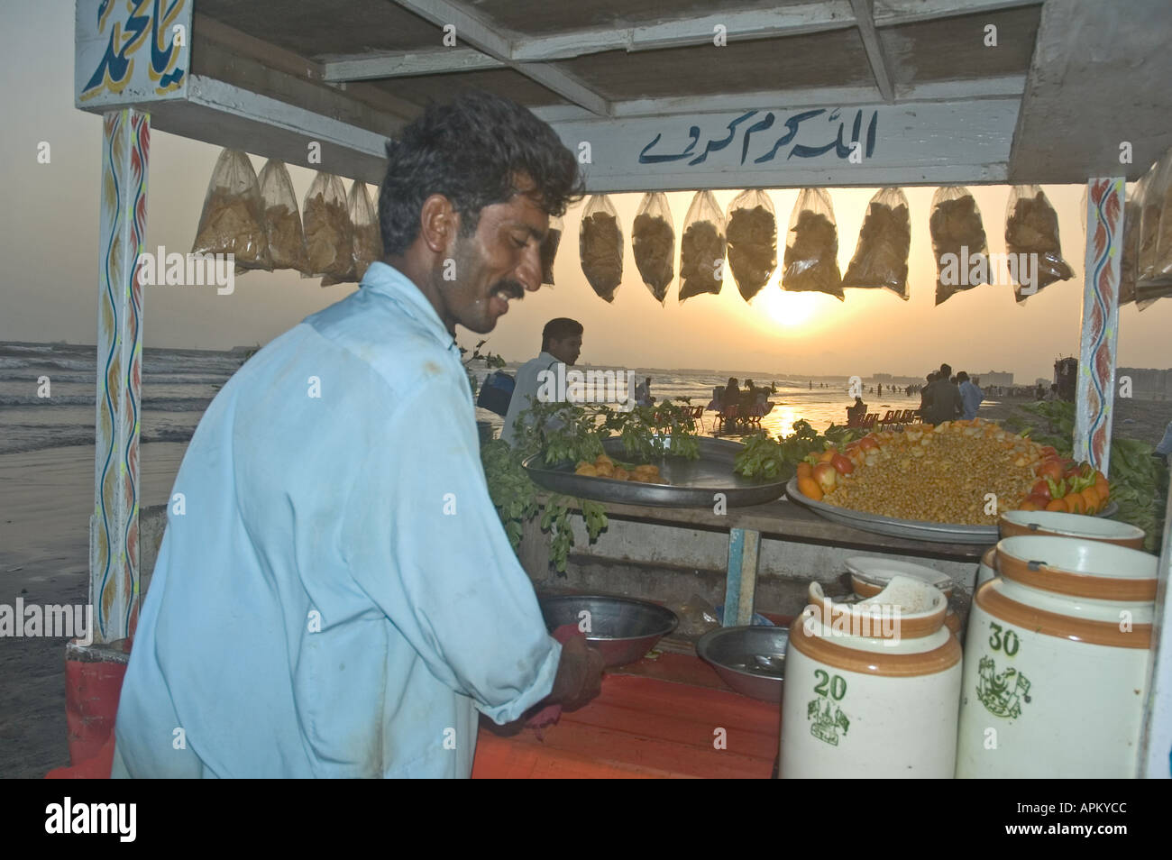 A street stall cook behind his counter on Clifton Beach in Karachi ...
