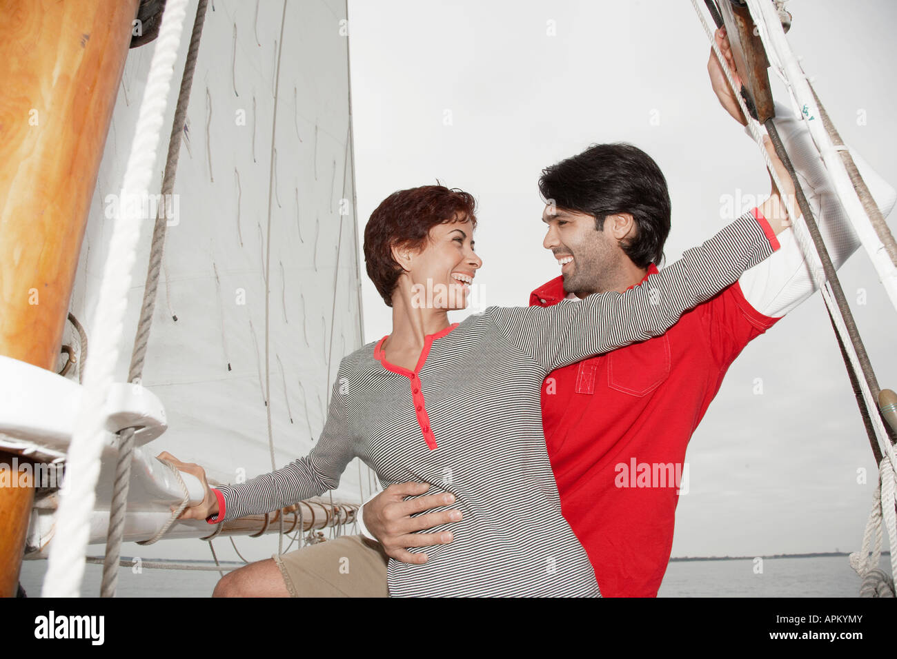 Couple laughing in sailing boat (low angle view Stock Photo - Alamy