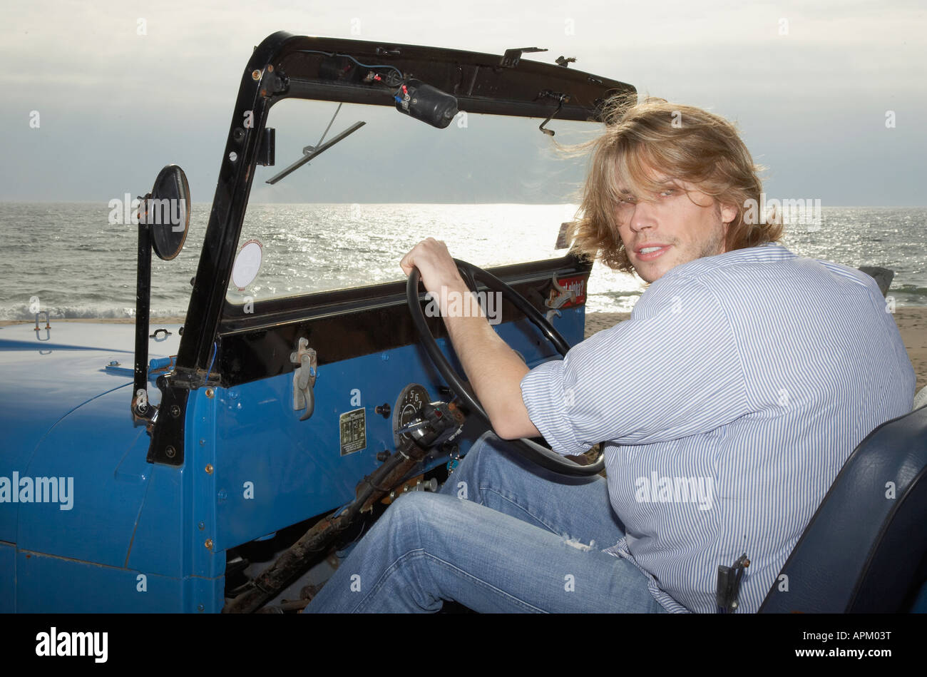 Young man driving beach buggy Stock Photo - Alamy