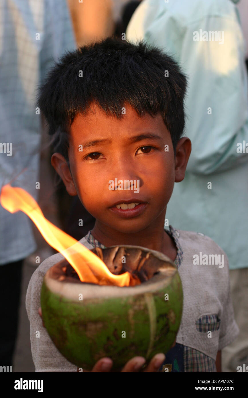 Cambodian boy with flame in cocunut Stock Photo - Alamy
