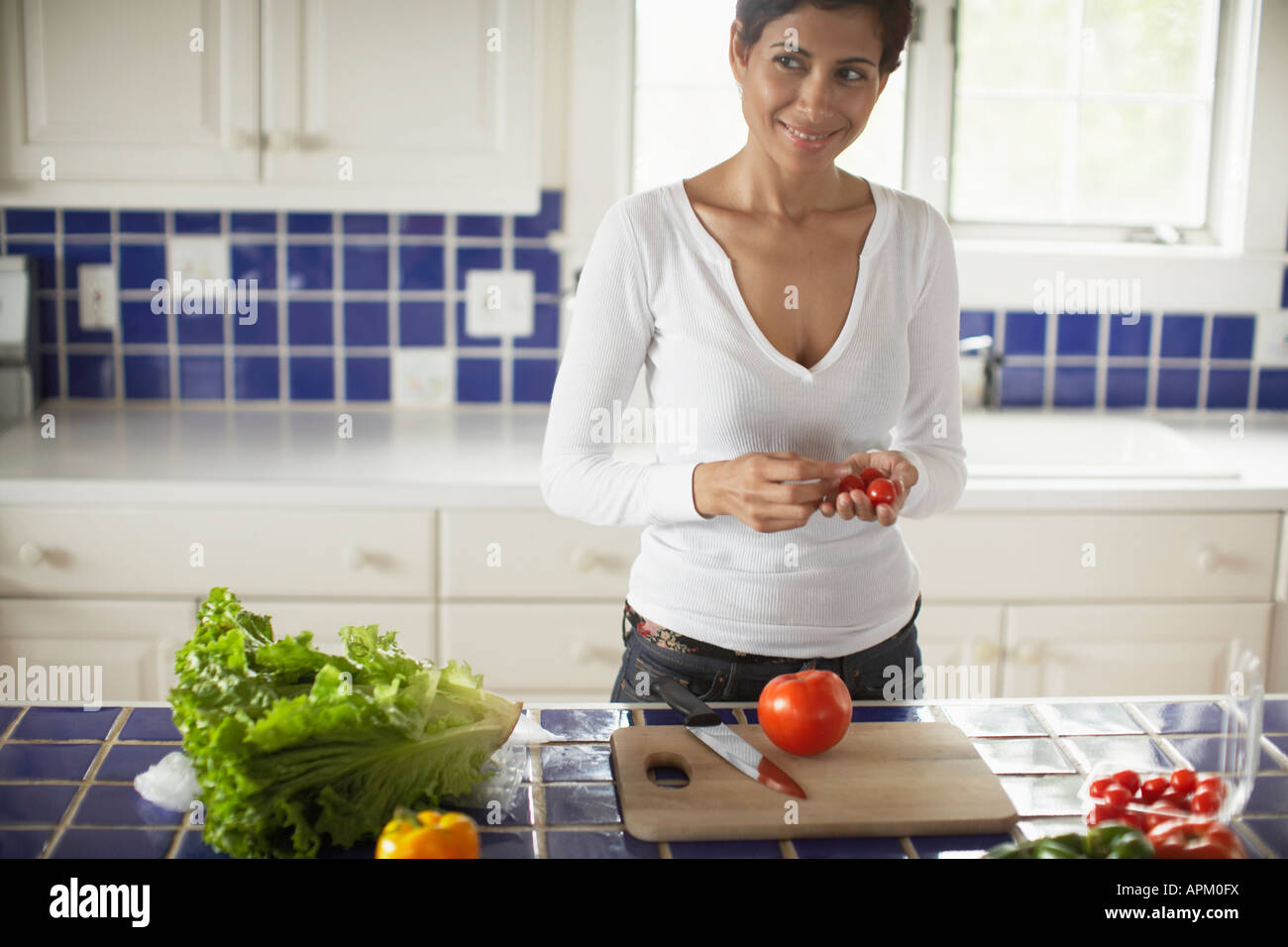 Woman cooking in kitchen Stock Photo - Alamy