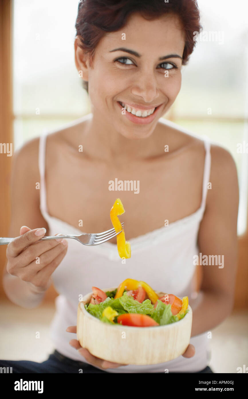 Woman eating salad Stock Photo - Alamy