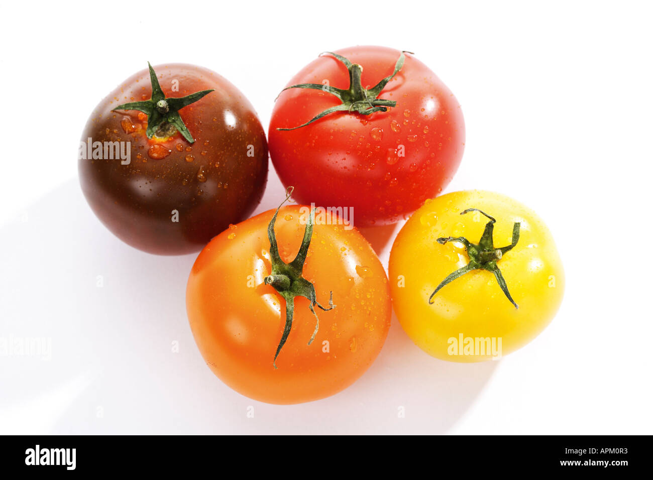 Four colorful red tomatoes hi-res stock photography and images - Alamy