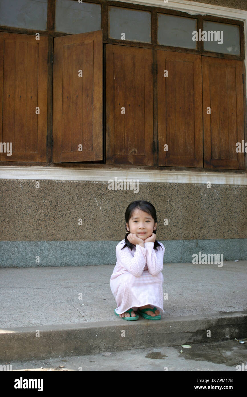 young girl crouching beside pavement Stock Photo - Alamy