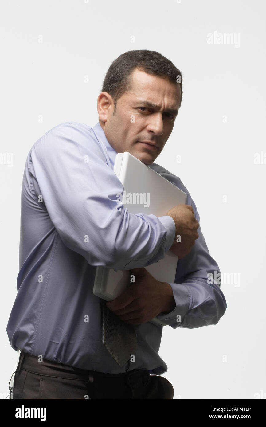Man holding and protecting laptop computer Stock Photo - Alamy