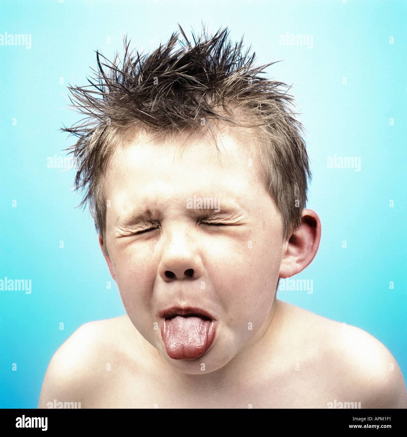 portrait of a young boy poking his tongue out Stock Photo - Alamy