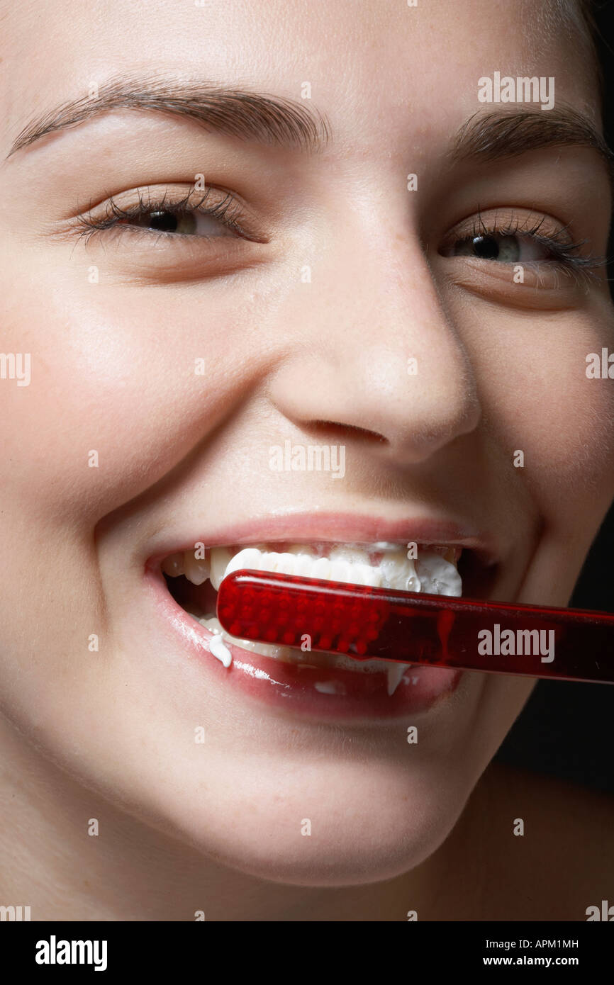 Woman brushing teeth, close-up Stock Photo - Alamy