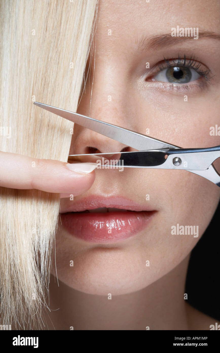 Young woman cutting her hair, close-up Stock Photo - Alamy