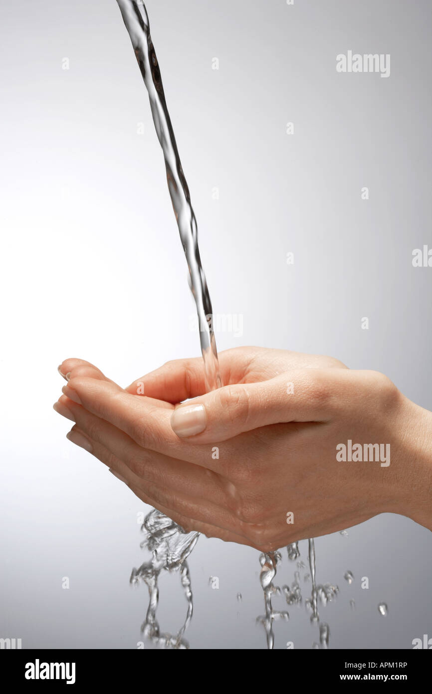 Water pouring on hands, close-up Stock Photo - Alamy