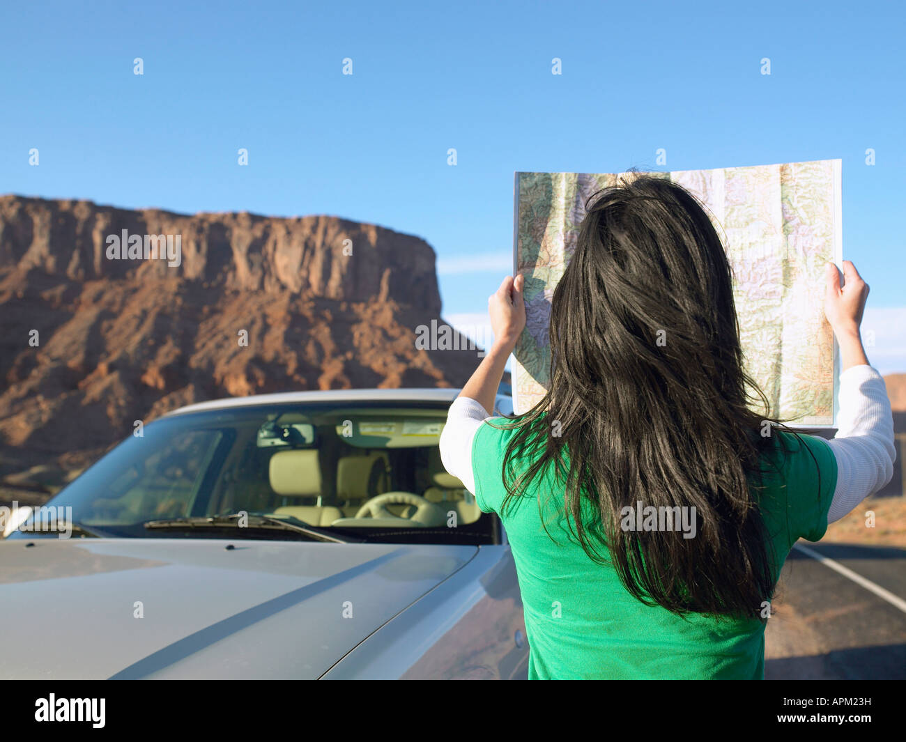 Woman reading map by car, rear view, Moab, Utah, USA Stock Photo - Alamy