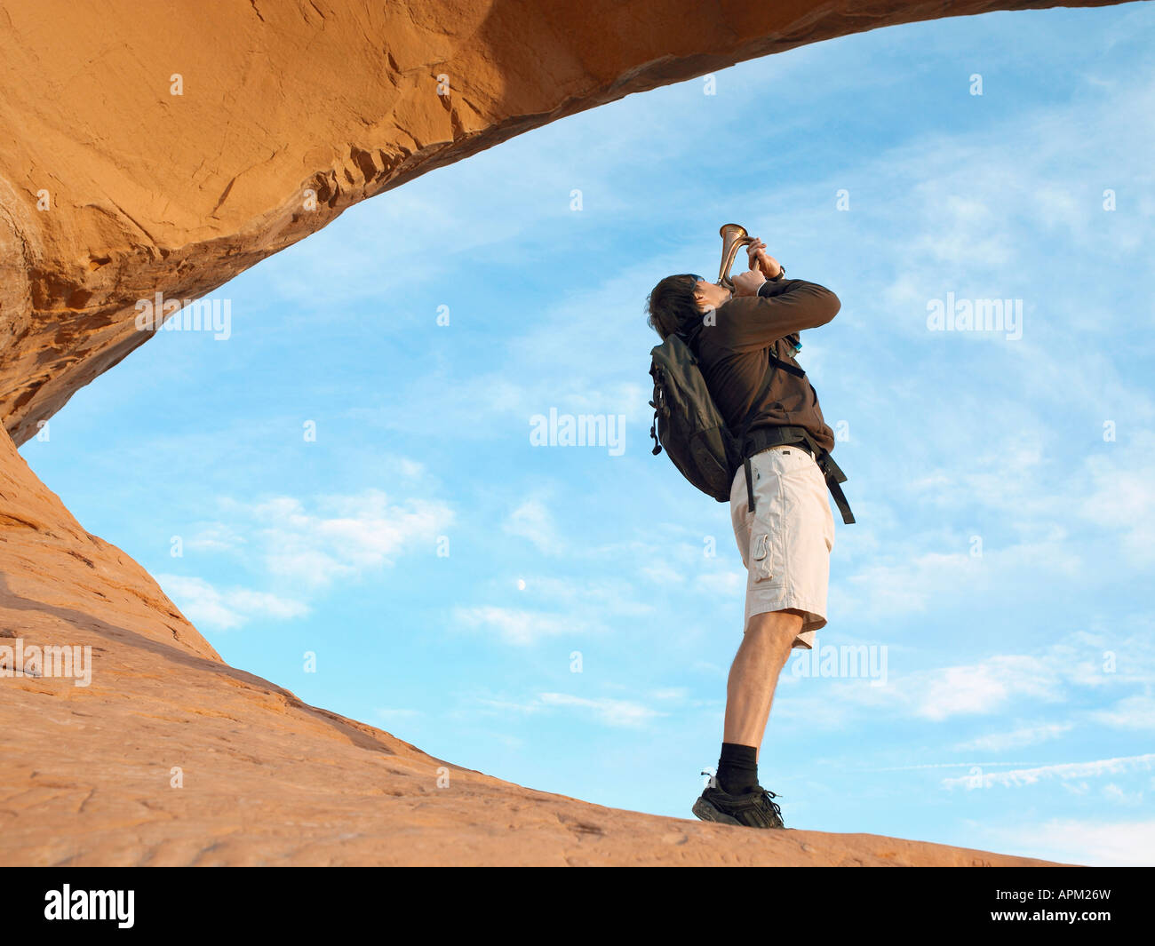 Male hiker playing bugle, low angle view Stock Photo - Alamy