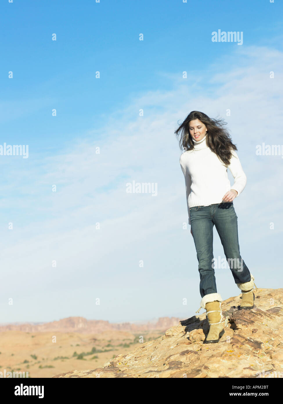 Young woman walking on rock Stock Photo - Alamy