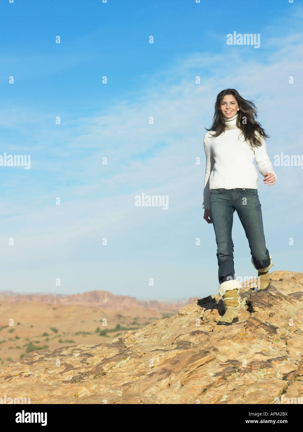 Young woman walking on rock Stock Photo - Alamy
