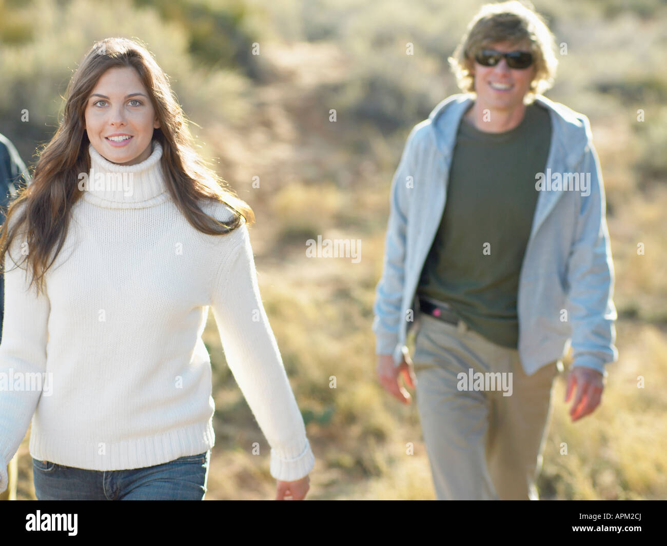 Man and woman walking Stock Photo - Alamy