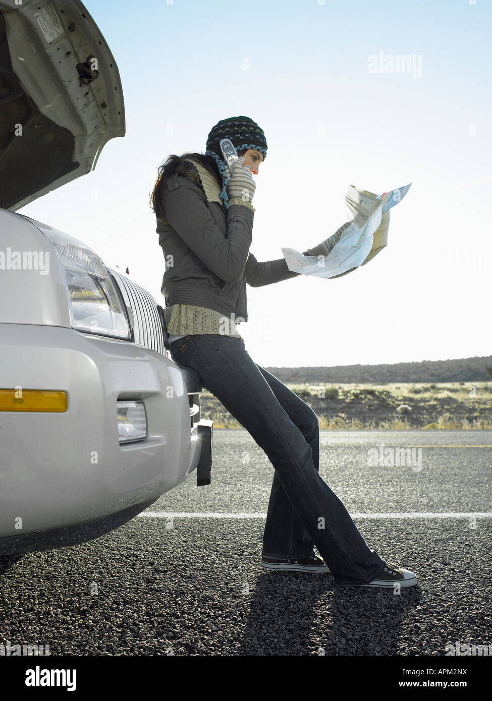Woman with road map talking on cell phone by broken car Stock Photo - Alamy