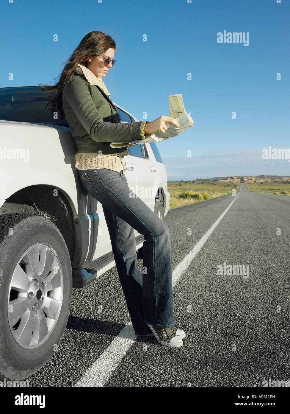 Woman reading road map by car on highway Stock Photo - Alamy