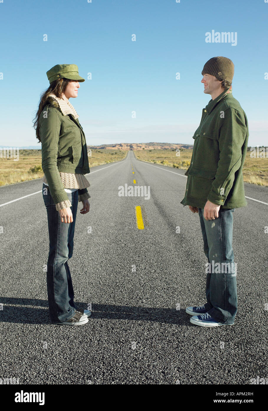 Woman and man standing face to face on highway Stock Photo - Alamy