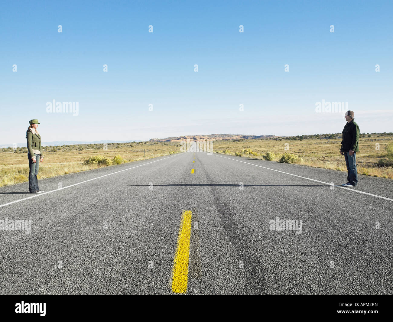 Woman and man on opposite sides of road Stock Photo - Alamy